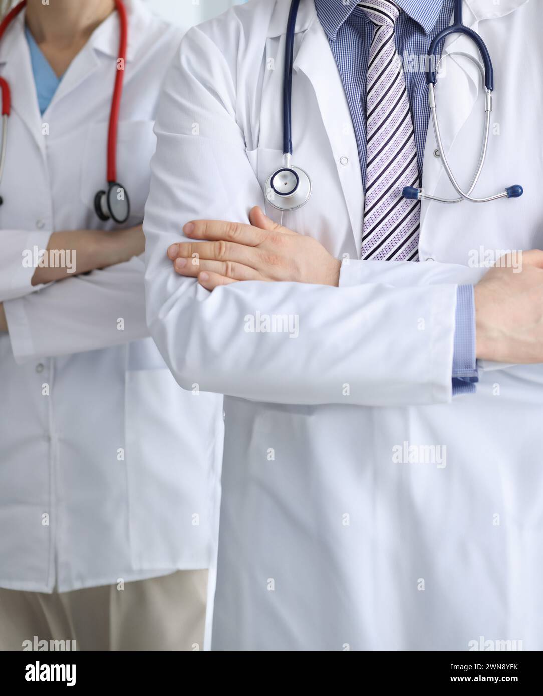 Doctors man and woman crossed arms over chest Stock Photo - Alamy