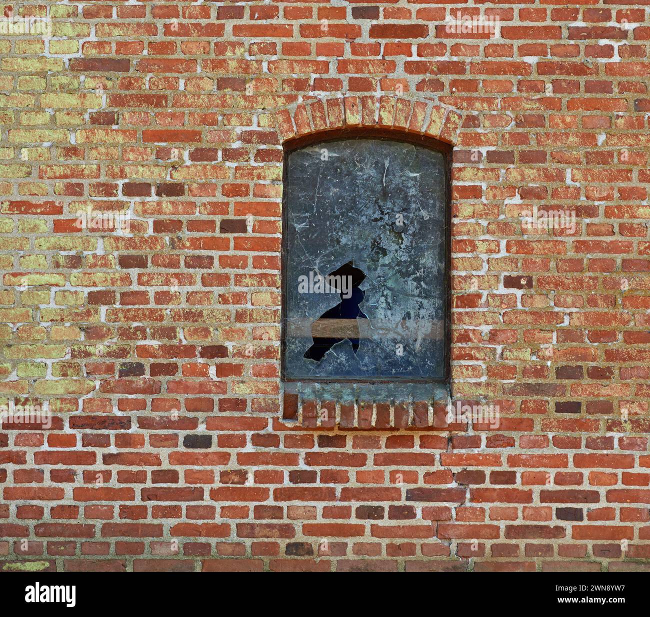Old, broken window and exterior with brick wall of abandoned house ...