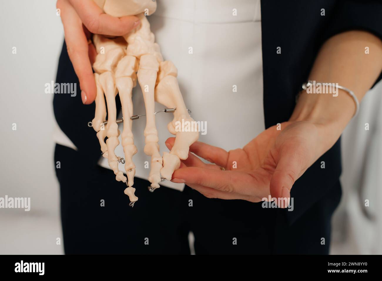 Doctor explaining operation to foot on bone model Stock Photo - Alamy
