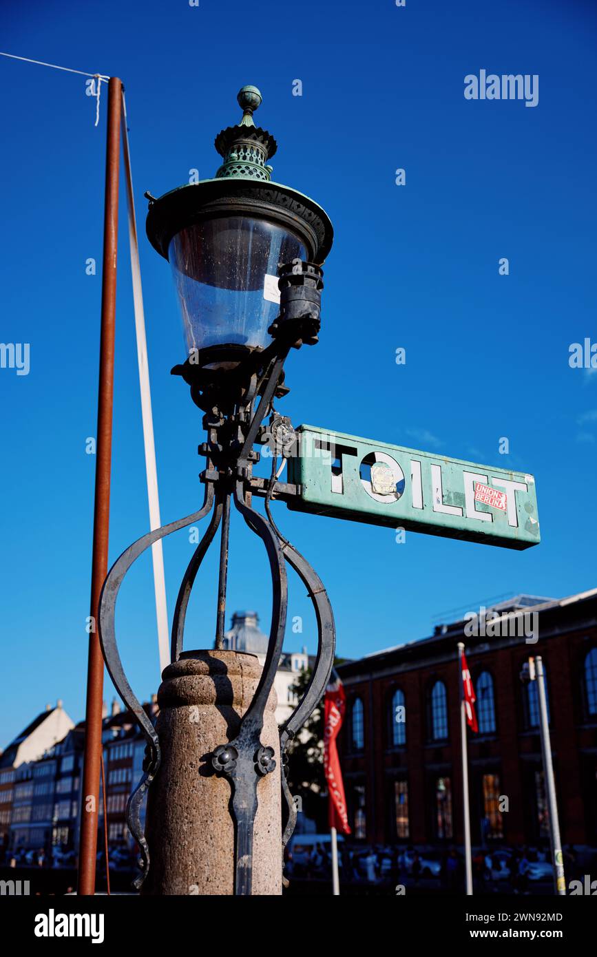 Toilet sign on lamp post at Nyhavn, Copenhagen, Denmark Stock Photo - Alamy