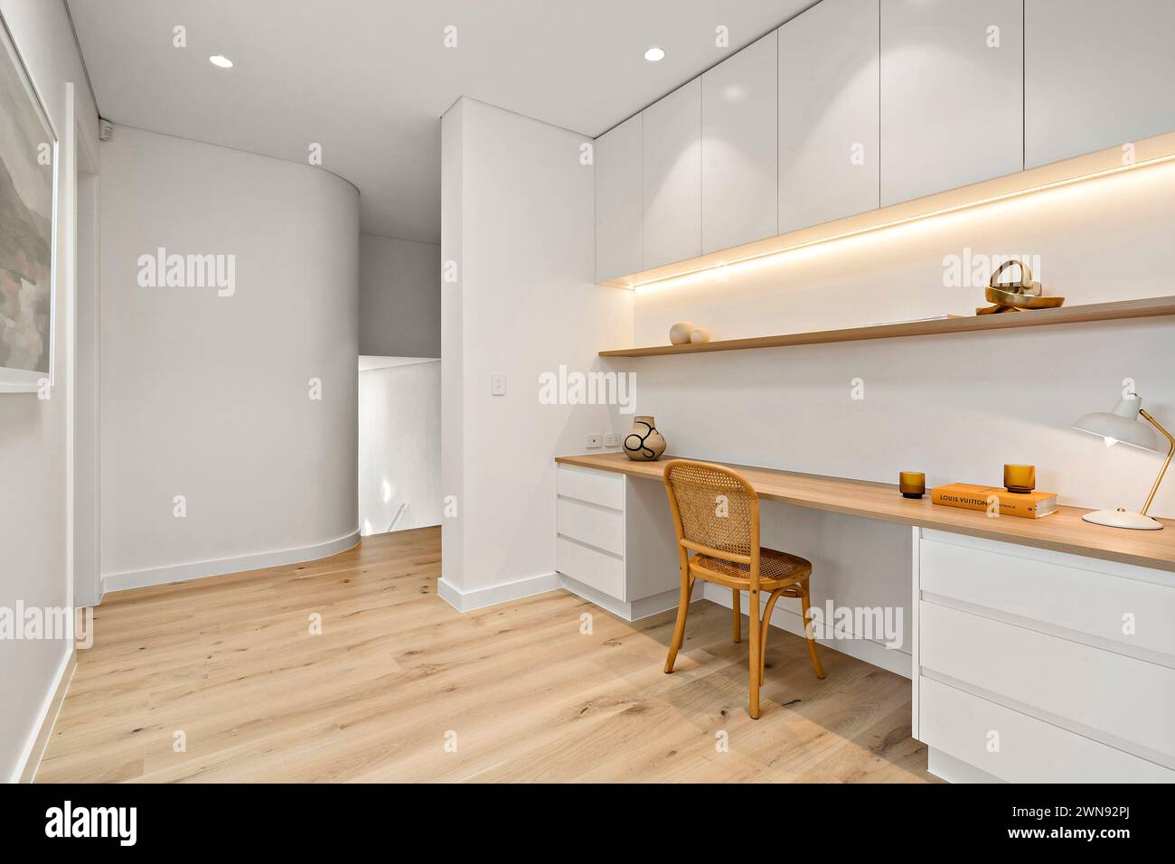 A modern study area with two workstations, chairs, and white storage ...