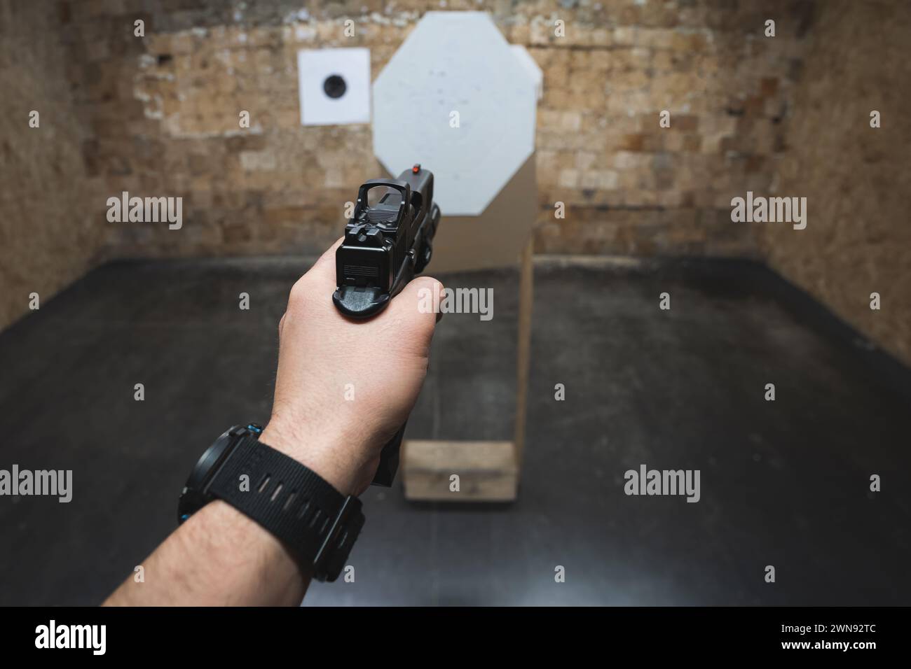 Tactical shooting from a pistol g19 with a red dot at targets in a ...