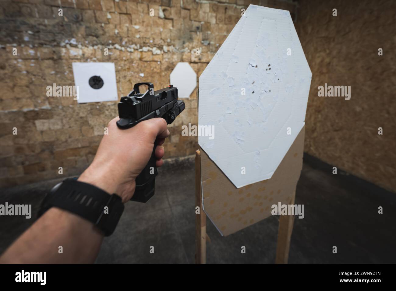 Tactical shooting from a pistol with a red dot at targets in a shooting ...