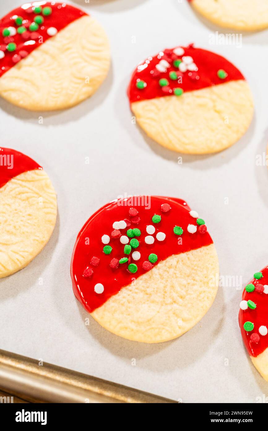 Decorating with Red Melted Chocolate and Vibrant Green Sprinkles Stock ...