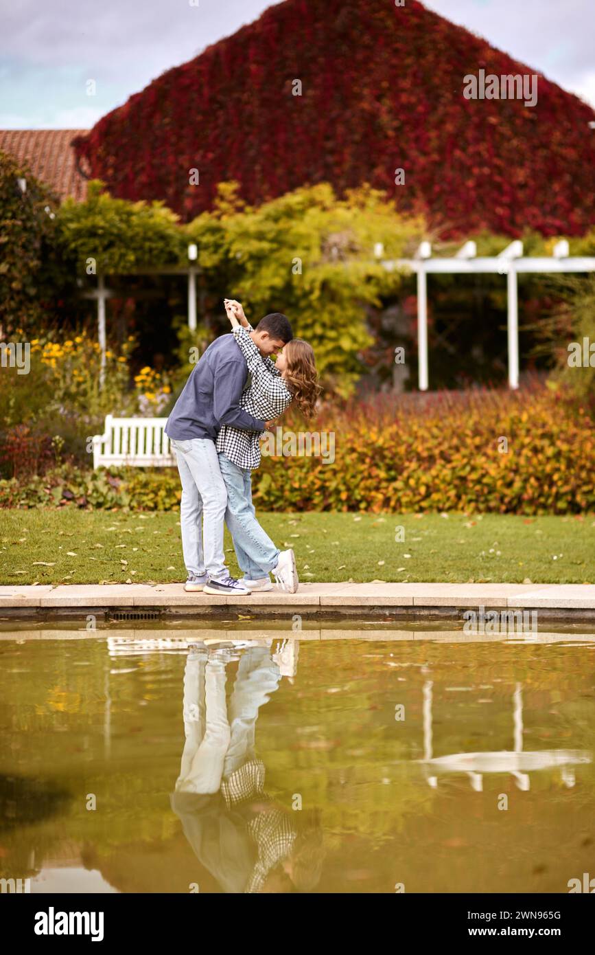 Young couple kissing and rejoices at the lake. lovely young couple ...