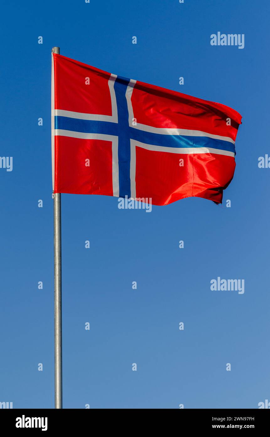 Norwegian flag on a blue sky background Stock Photo - Alamy
