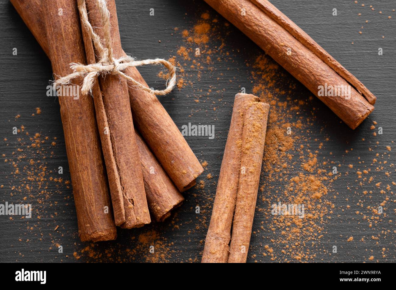 Cinnamon sticks and cinnamon powder on dark rustic background, healthy ...