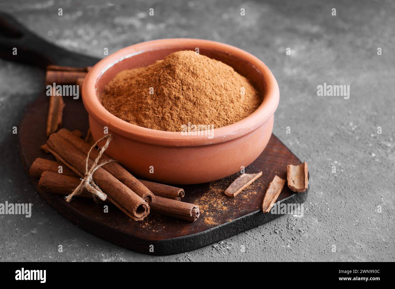 Cinnamon sticks and cinnamon powder on dark rustic background, healthy ...