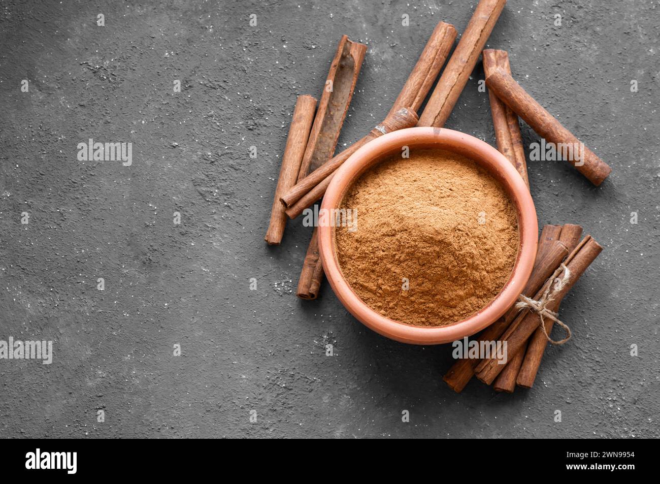 Cinnamon sticks and cinnamon powder on dark rustic background, healthy ...