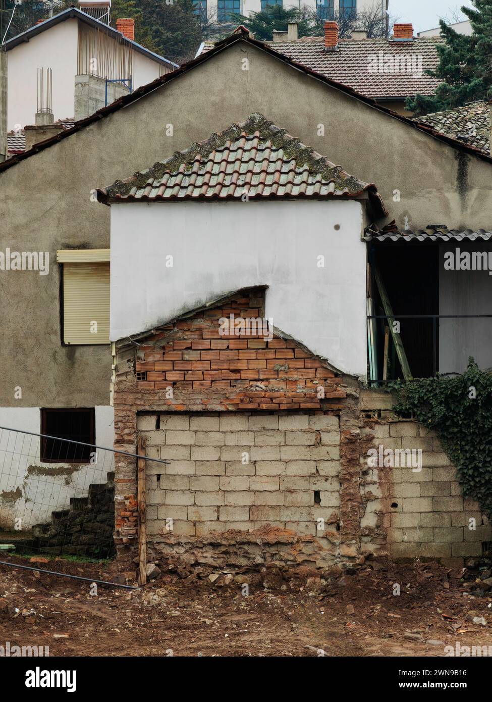 Decay above. Layers of destruction on old house rooftops Stock Photo ...