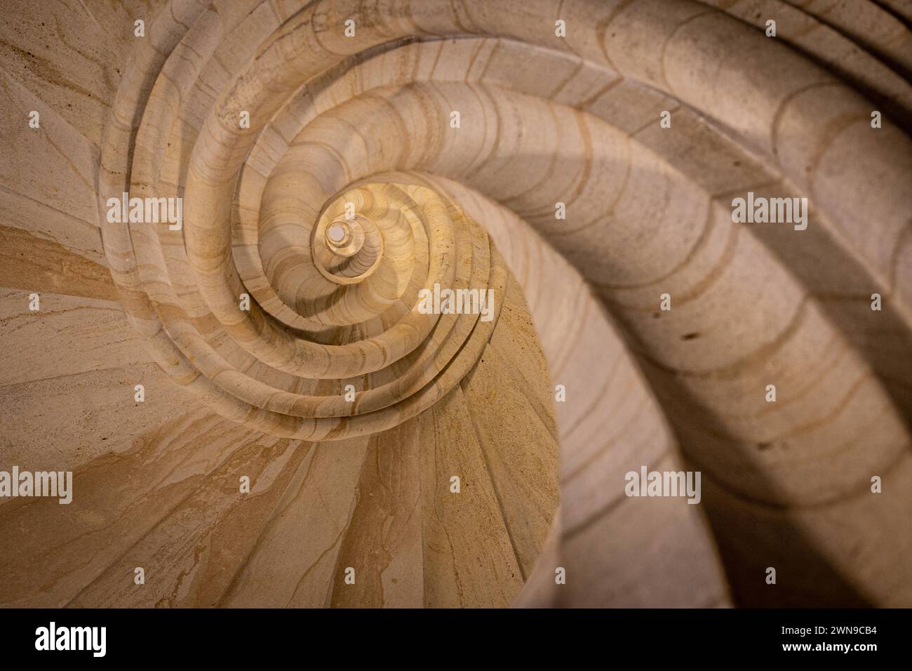 View of a nautilus-shaped spiral staircase in beige, which gives a ...