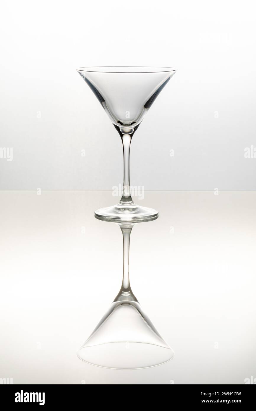 An inverted martini glass on a clear surface that radiates elegance and ...
