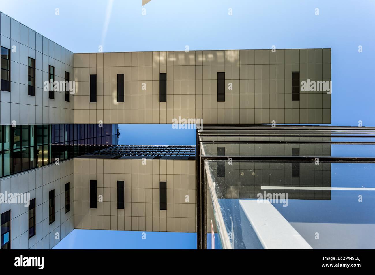 View of a modern connecting corridor between buildings with reflections ...