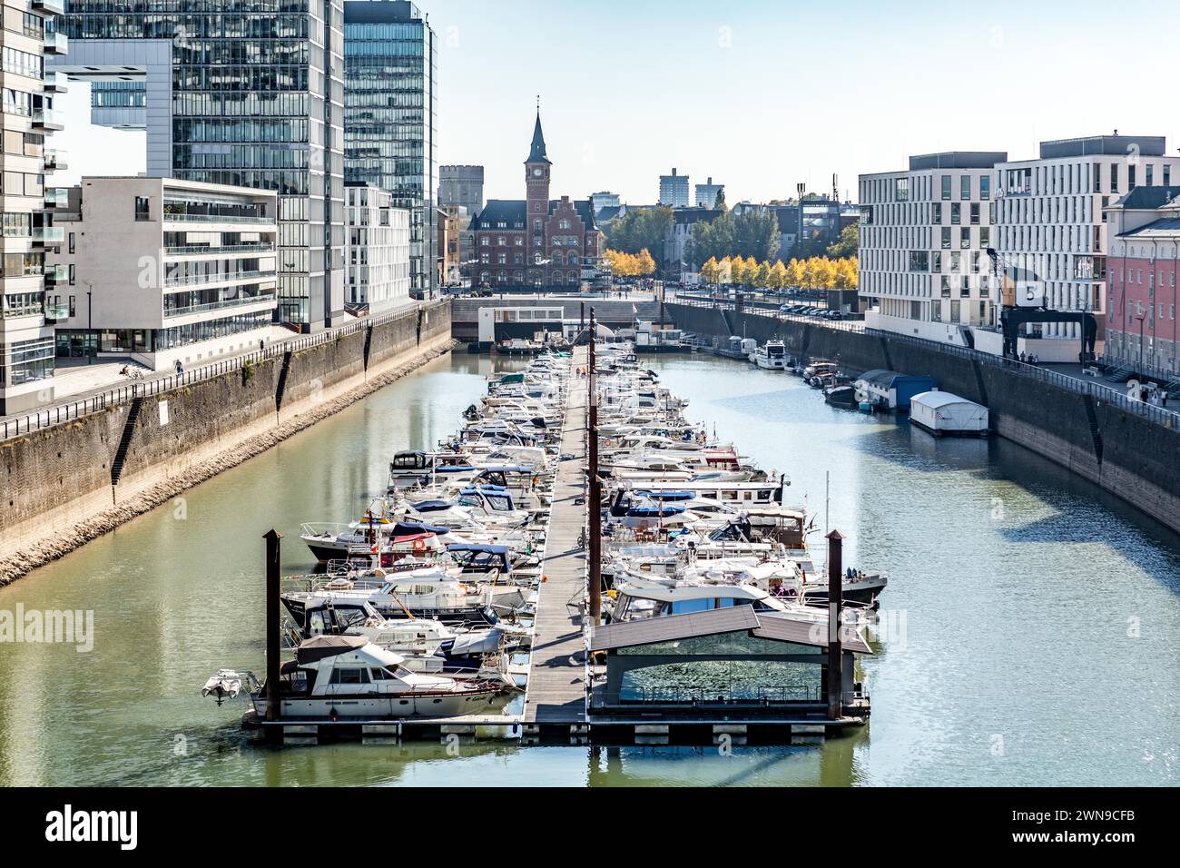 View of an urban waterway with boats and modern buildings under a clear ...