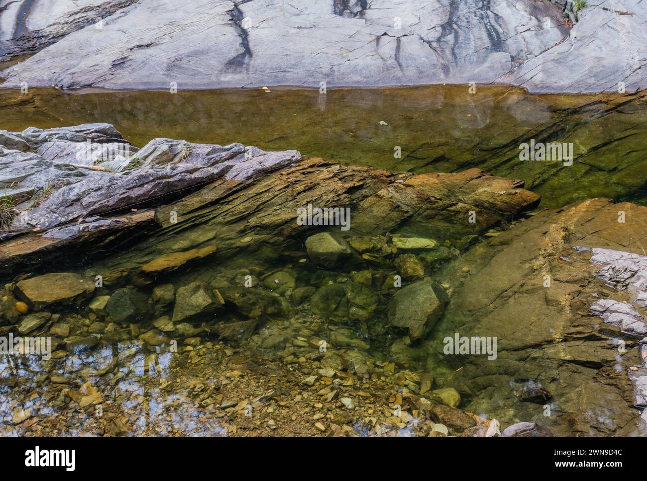 Large jagged boulders in shallow mountain stream in wilderness park in ...