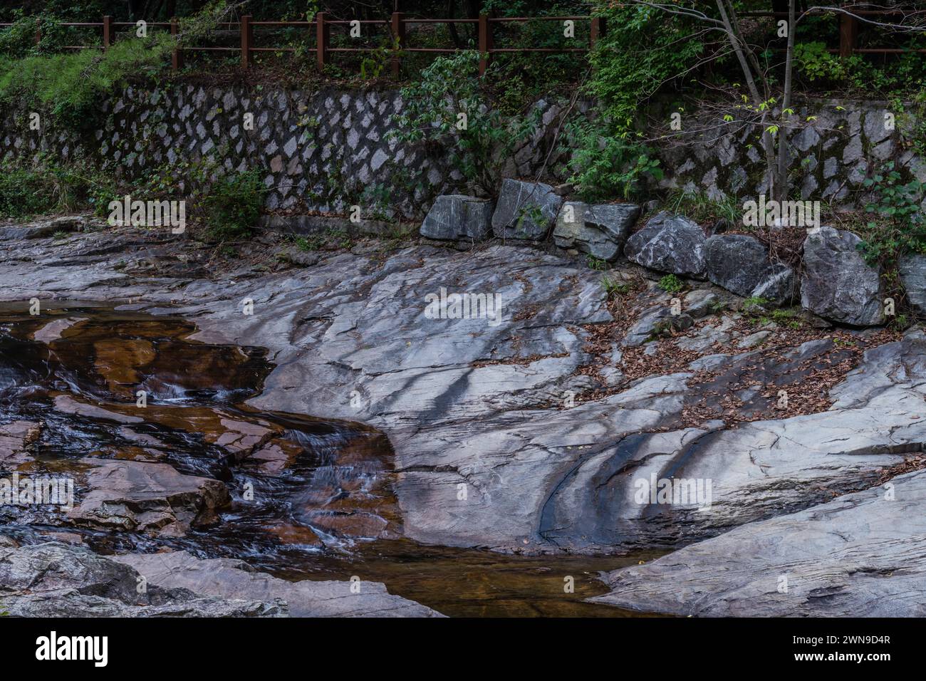 Shallow river cascading over large boulder in wilderness park in South Korea Stock Photo - Alamy