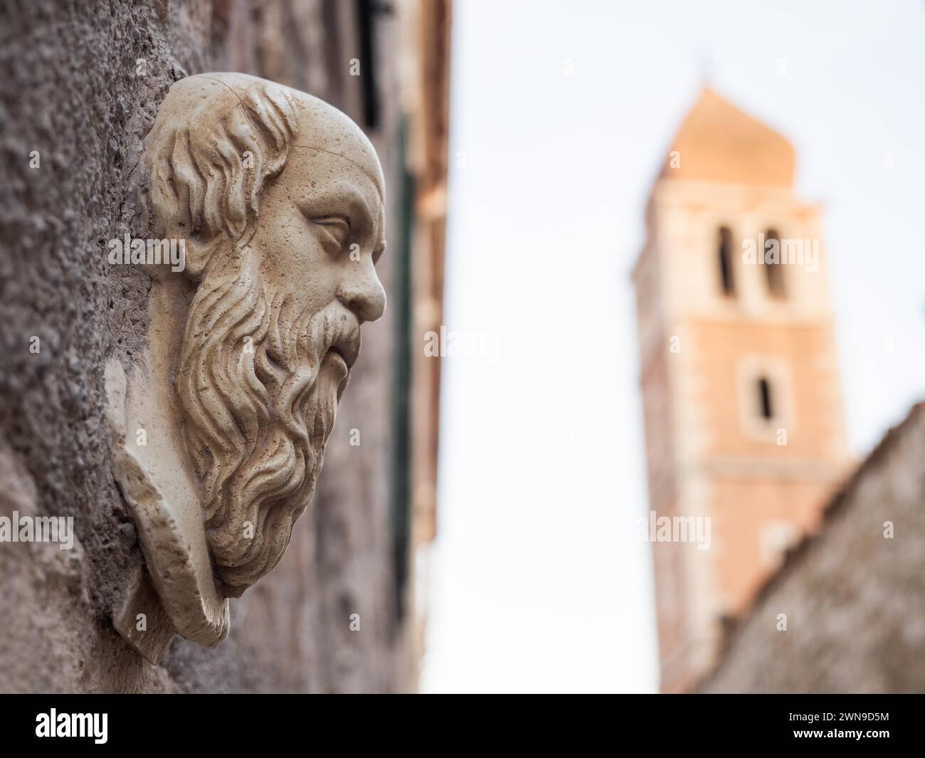 Stone relief, sculpture, behind church tower, face of a man, old town ...