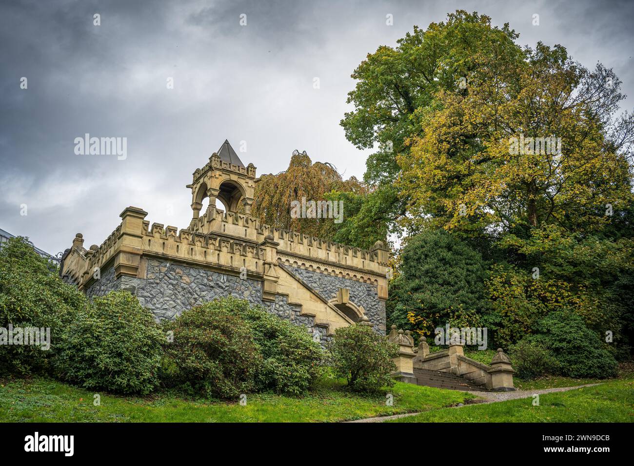 Castle-like building with battlements surrounded by trees under a ...