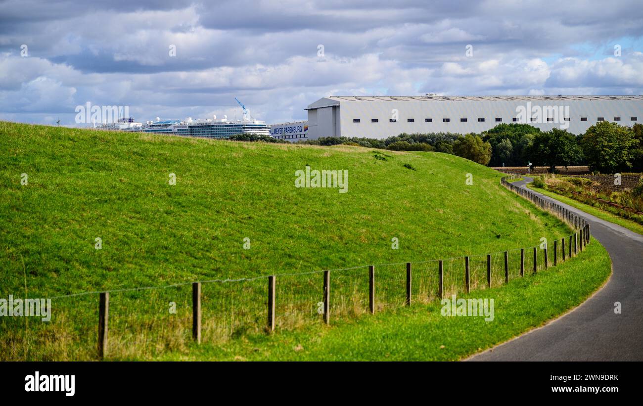 A ship is visible behind a hill, a rural path leads along a fence ...