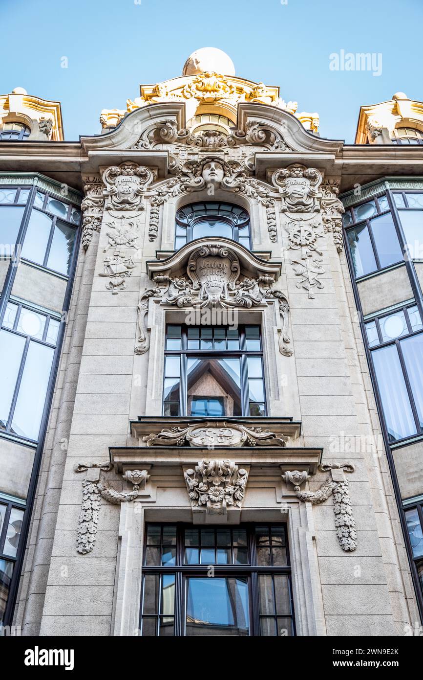 Baroque facade of a building with sculptural decorations and a gold ...