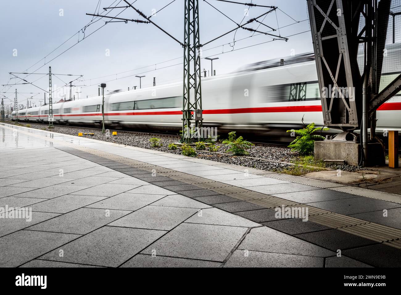 ICE express train passes the platform, captured in motion blur, Leipzig ...