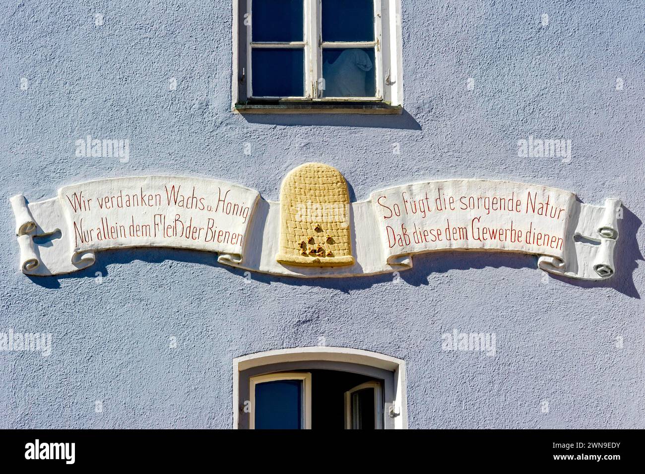 Slogan for the protection of bees on stuccoed banner, church gate ...