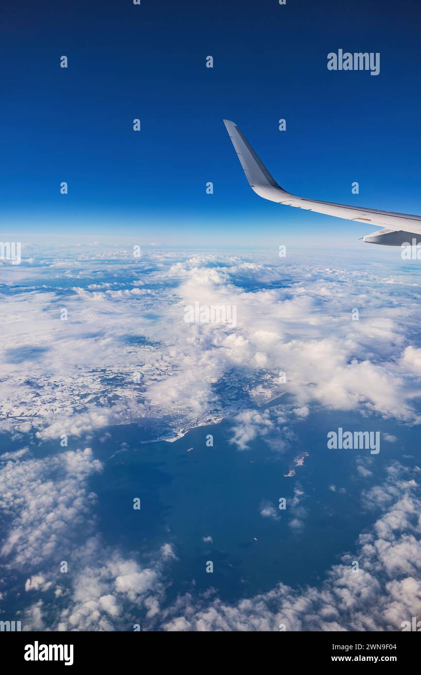 Airplane flying over color sky clouds during scenic sunset or sunrise ...