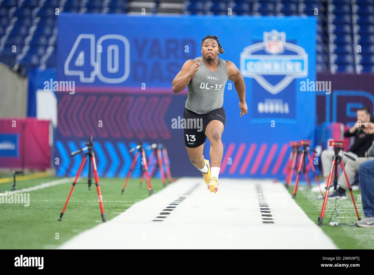 Michigan defensive lineman Kris Jenkins runs the 40-yard dash at the ...