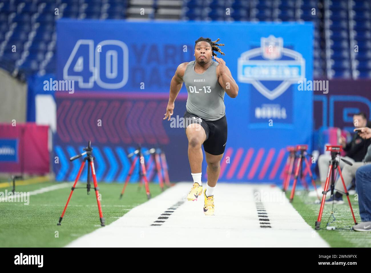 Michigan defensive lineman Kris Jenkins runs the 40-yard dash at the ...