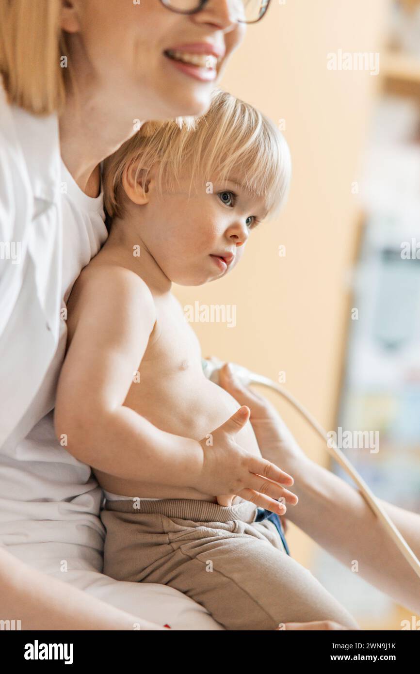 Small child being checked for heart murmur by heart ultrasound exam by ...