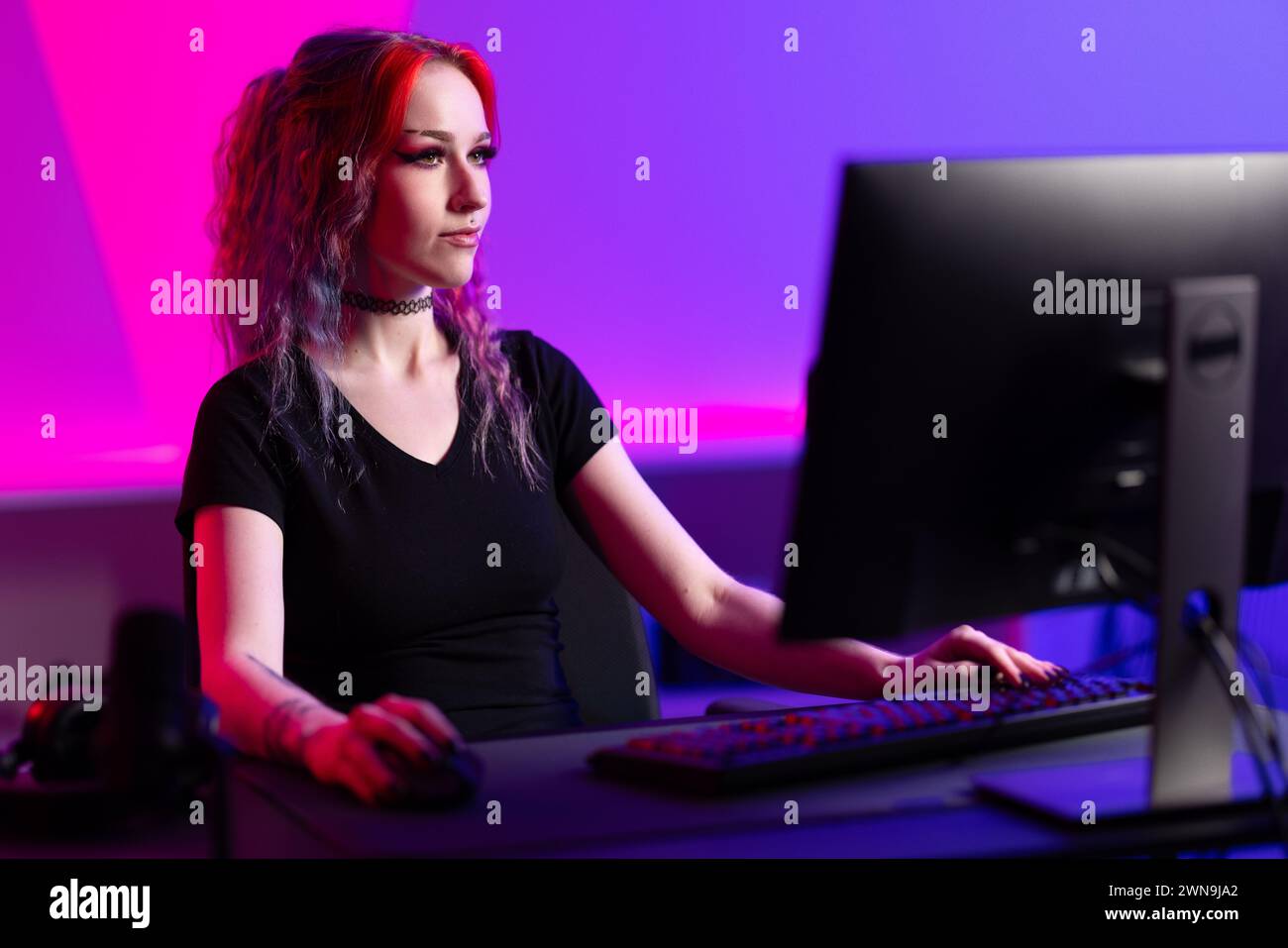 Focused Female Gamer Playing in a Vibrant Gaming Room Stock Photo - Alamy