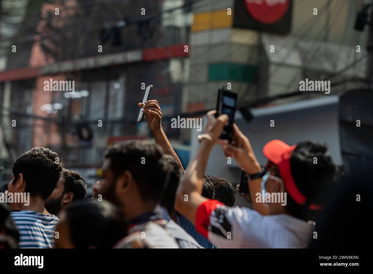 People take photos in front of the multi storey building during the aftermath. At least 46 ...