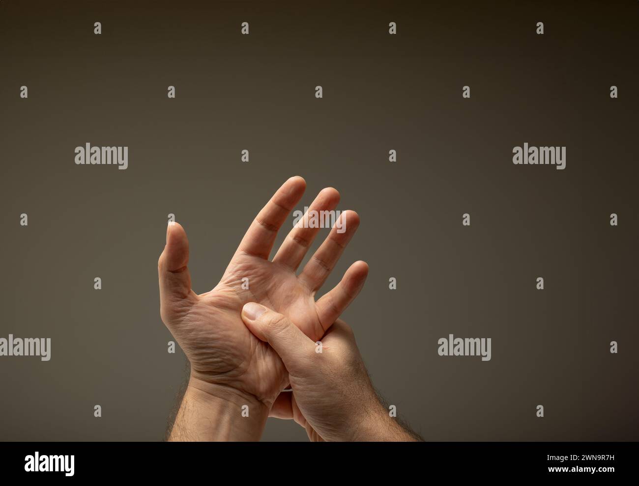 Caucasian man's hand isolated. Thumb pressure massaging inner open palm ...