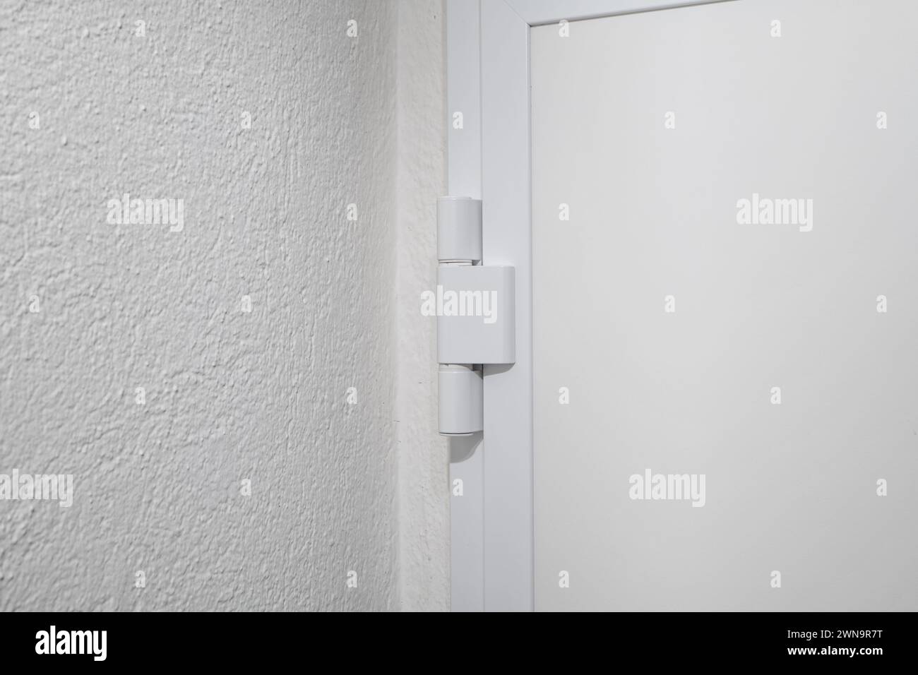 Plastic covered security door hinge of an interior door. Close up shot ...