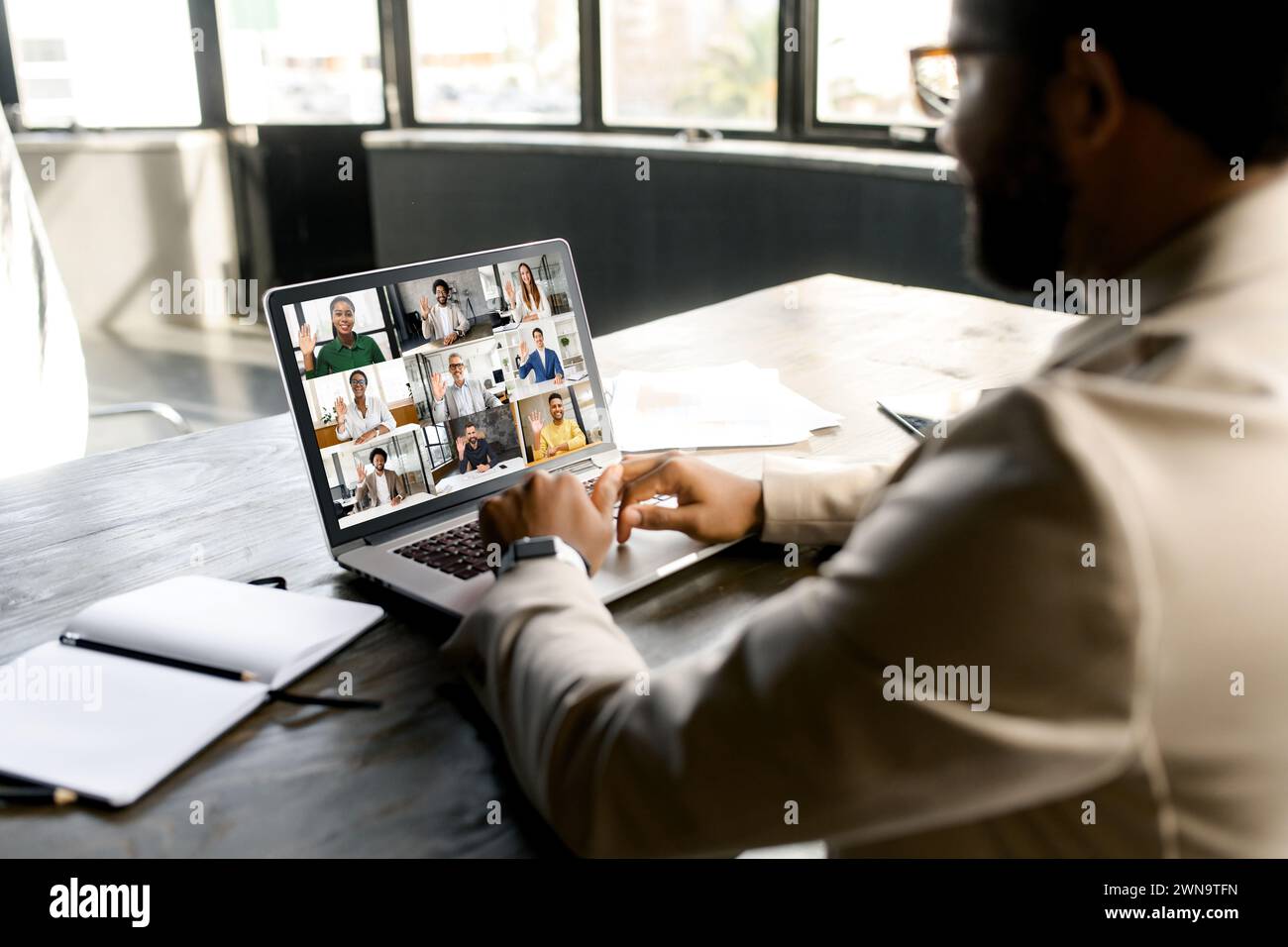 Businessman attentively participating in a video conference, with a ...