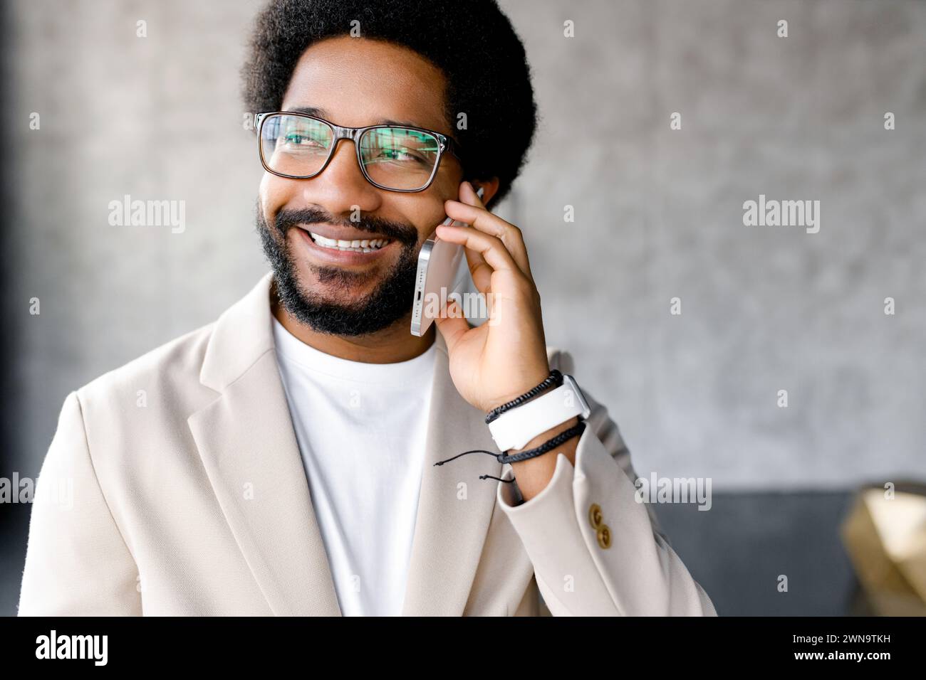 The young entrepreneur is captured mid-conversation, joyfully talking ...