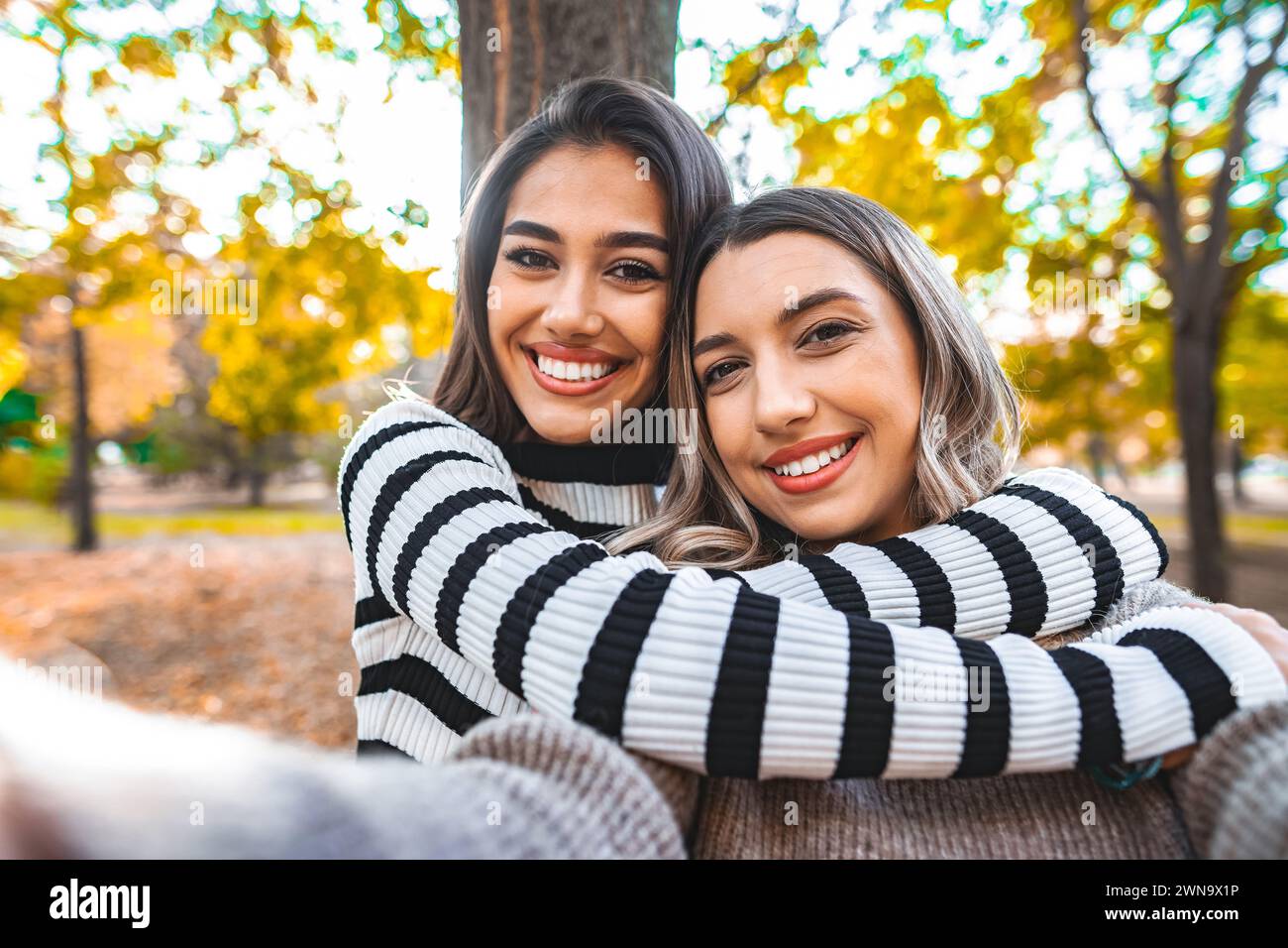 Two Women Hugging Each Other in a Park Stock Photo - Alamy
