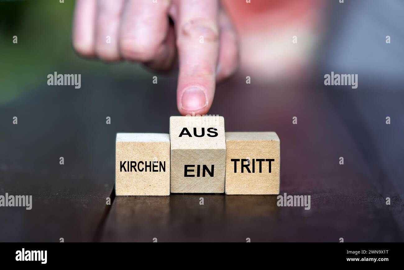 Hand turns wooden cube and changes the German expression ...