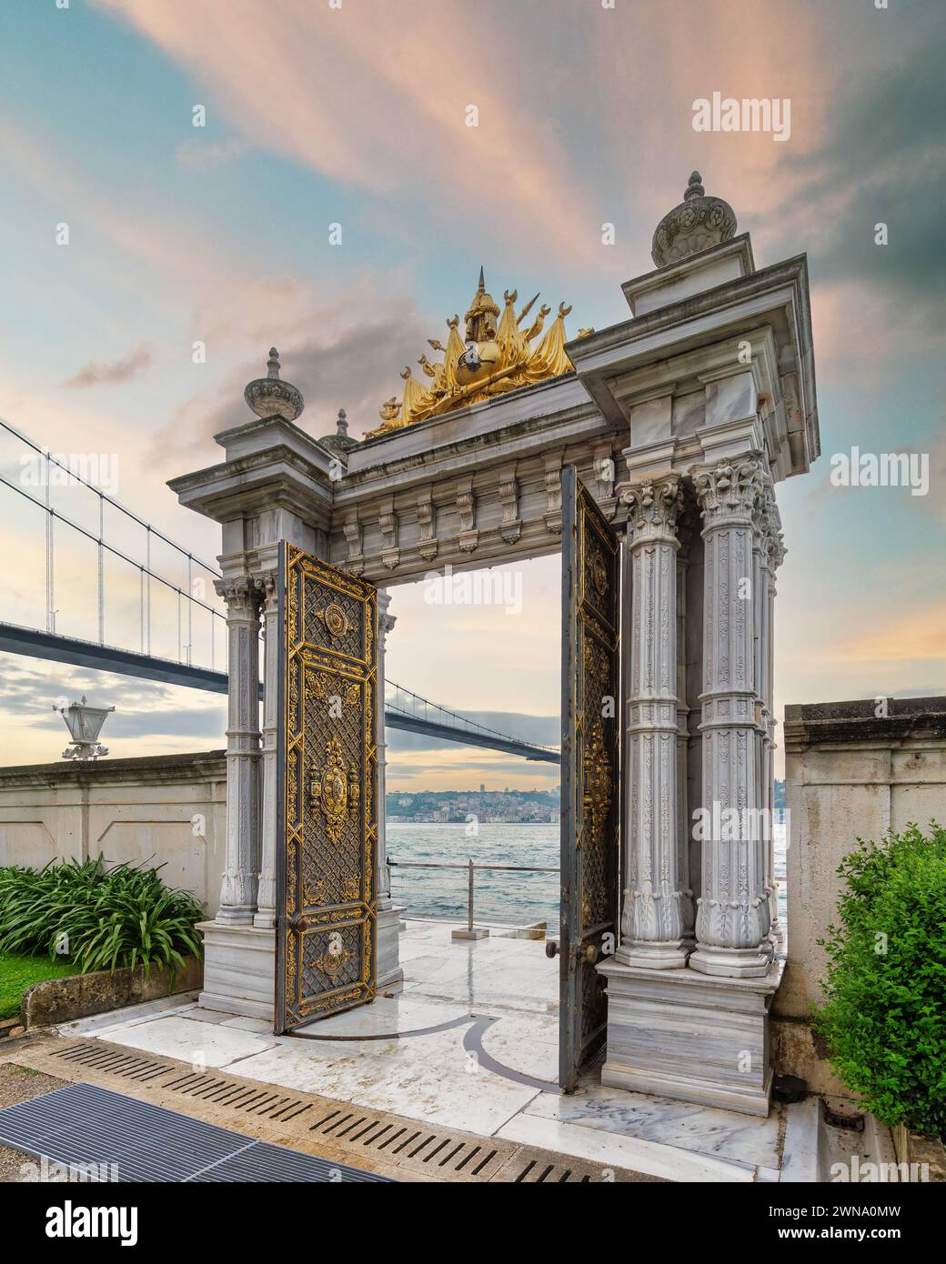 Marble gate with decorated open door leading to the Bosphorus Strait, with Bosphorus Bridge in ...