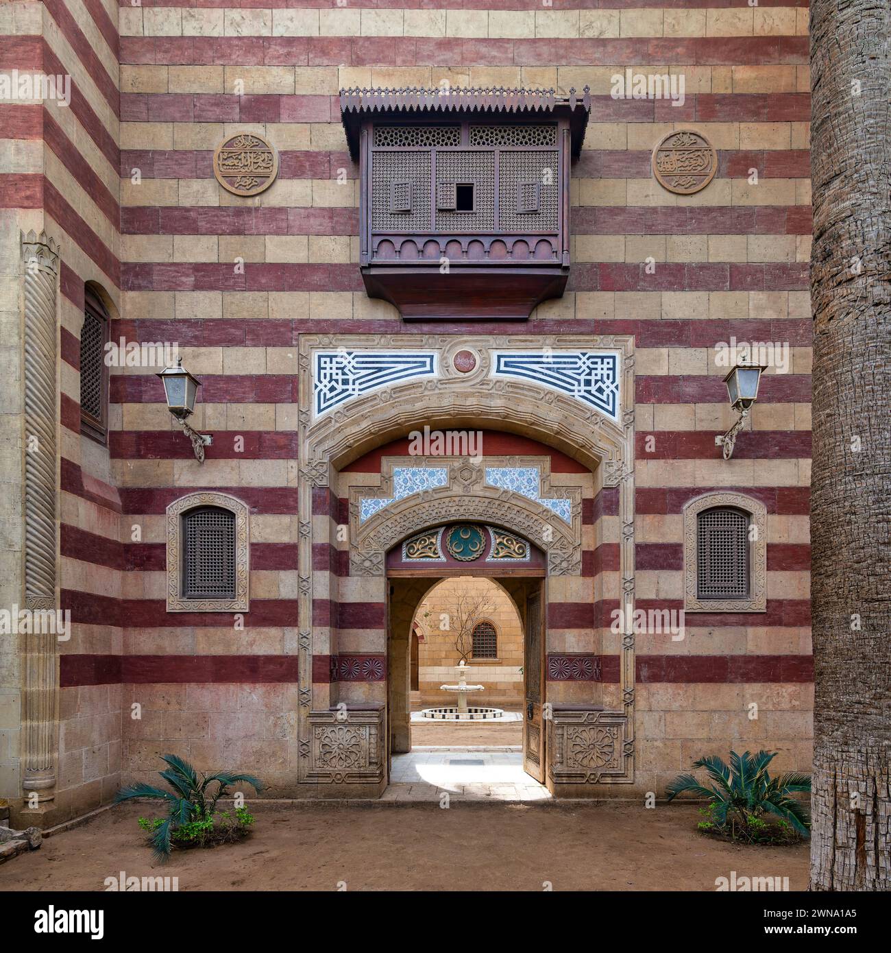 Striking red and white striped arched entrance leads into a Mamluk era ...