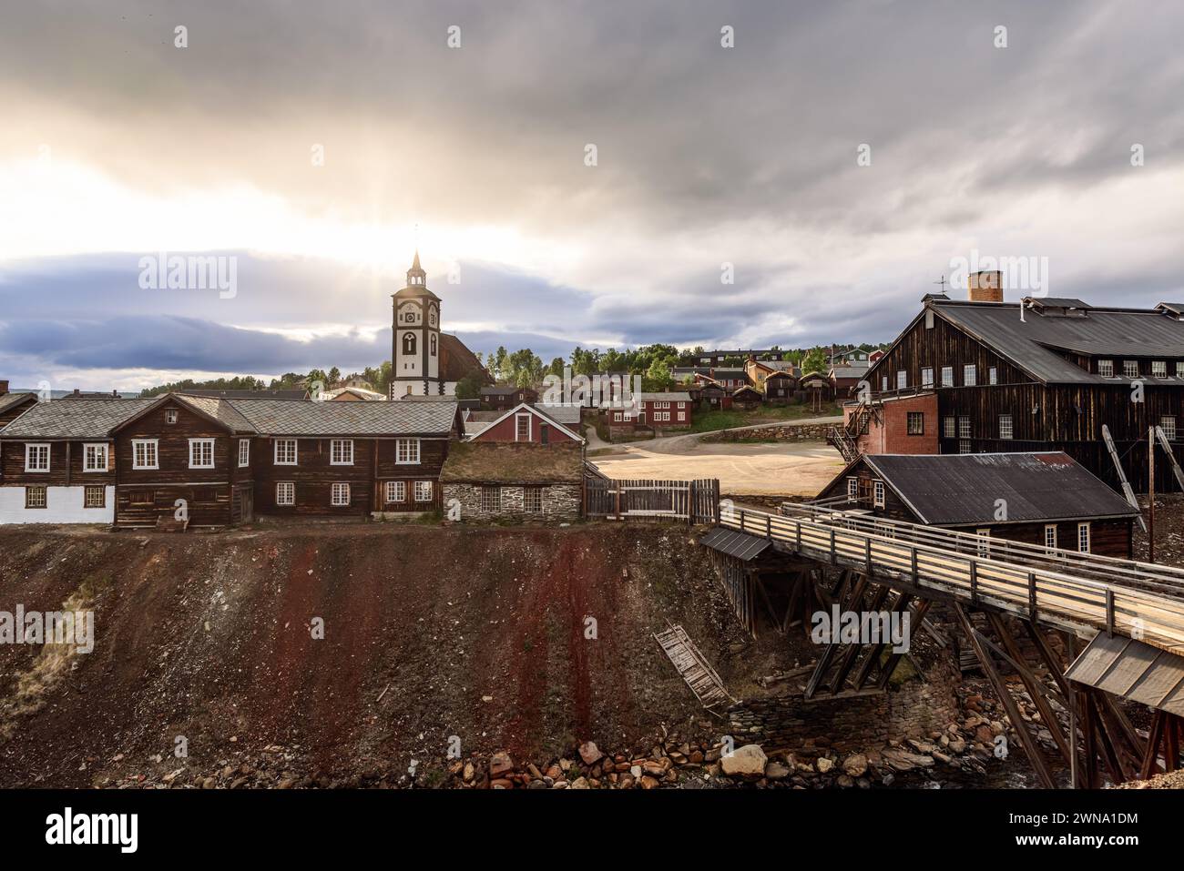 Sunset rays illuminate the charming landscape of Roros, featuring the ...