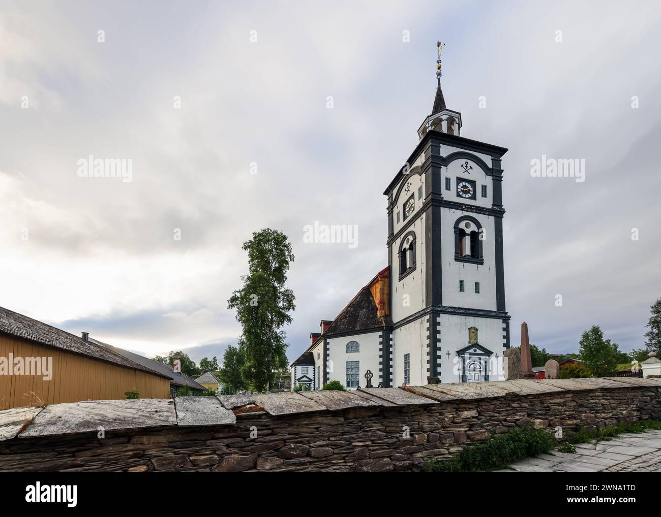 The Roros Church stands tall against a cloudy sky, its clock tower a ...