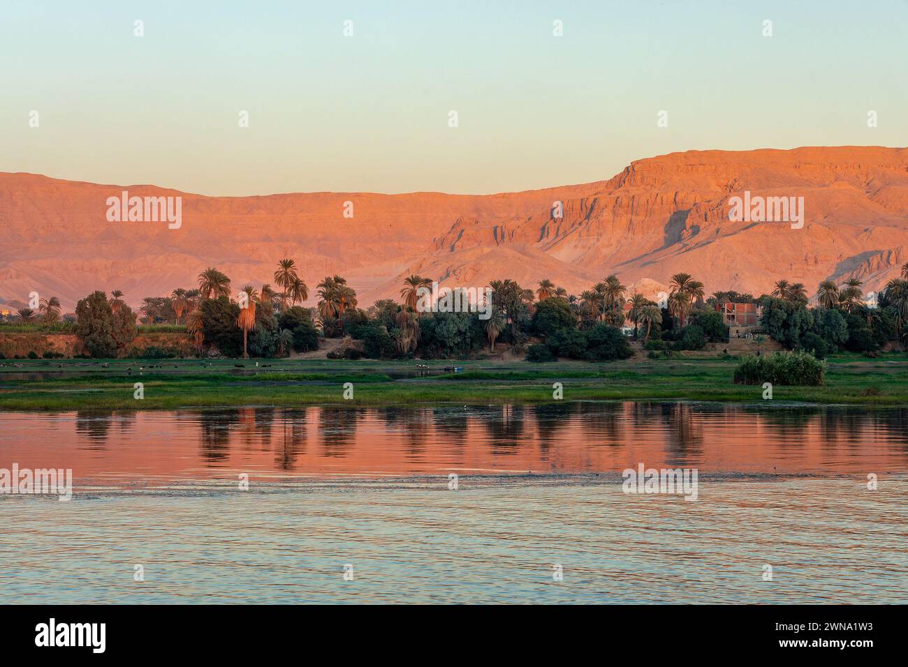 Landscape of mountains with palm trees on the Nile river banks, water ...
