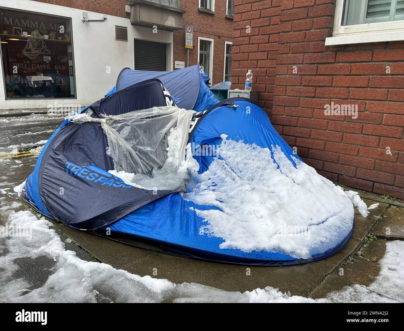 Tents, some flooded and collapsed, used by migrants and other people ...