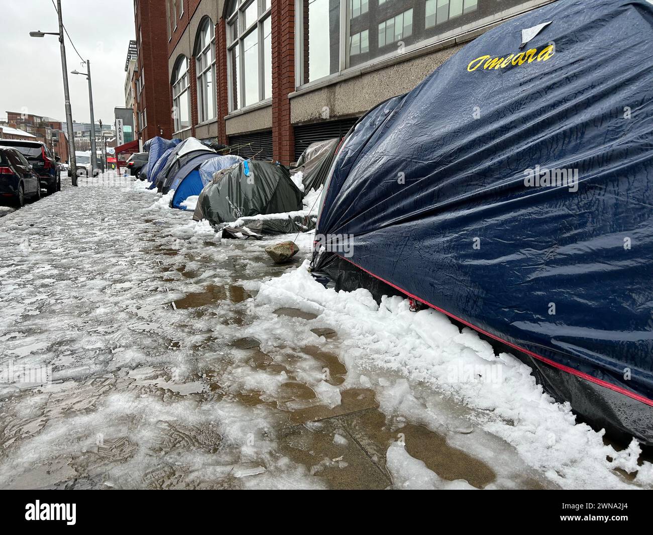 Tents, some flooded and collapsed, used by migrants and other people ...