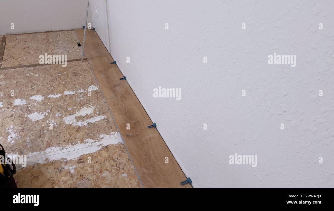 Precision in Progress: Installing a Vinyl Floorboard Stock Photo - Alamy