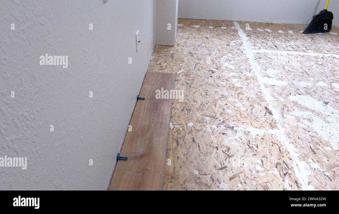 Precision in Progress: Installing a Vinyl Floorboard Stock Photo - Alamy