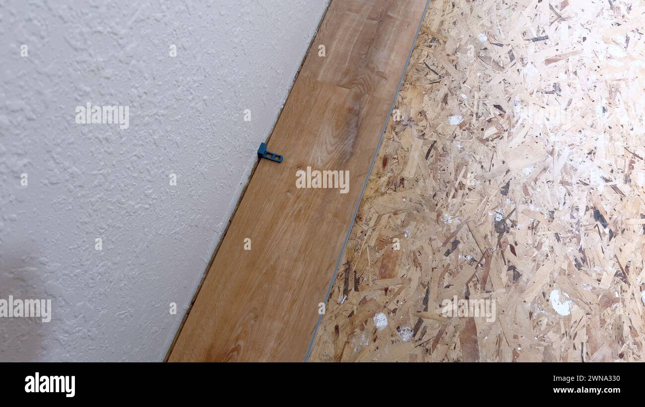 Precision in Progress: Installing a Vinyl Floorboard Stock Photo - Alamy