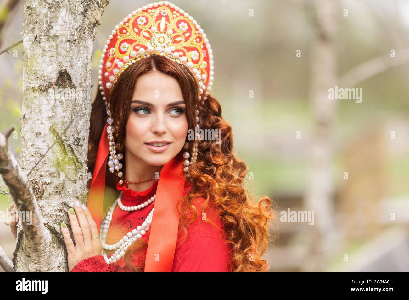 russian girl in traditional russian sarafan and kokoshnik embroidering ...