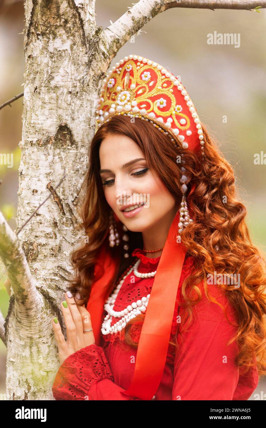russian girl in traditional russian sarafan and kokoshnik embroidering ...